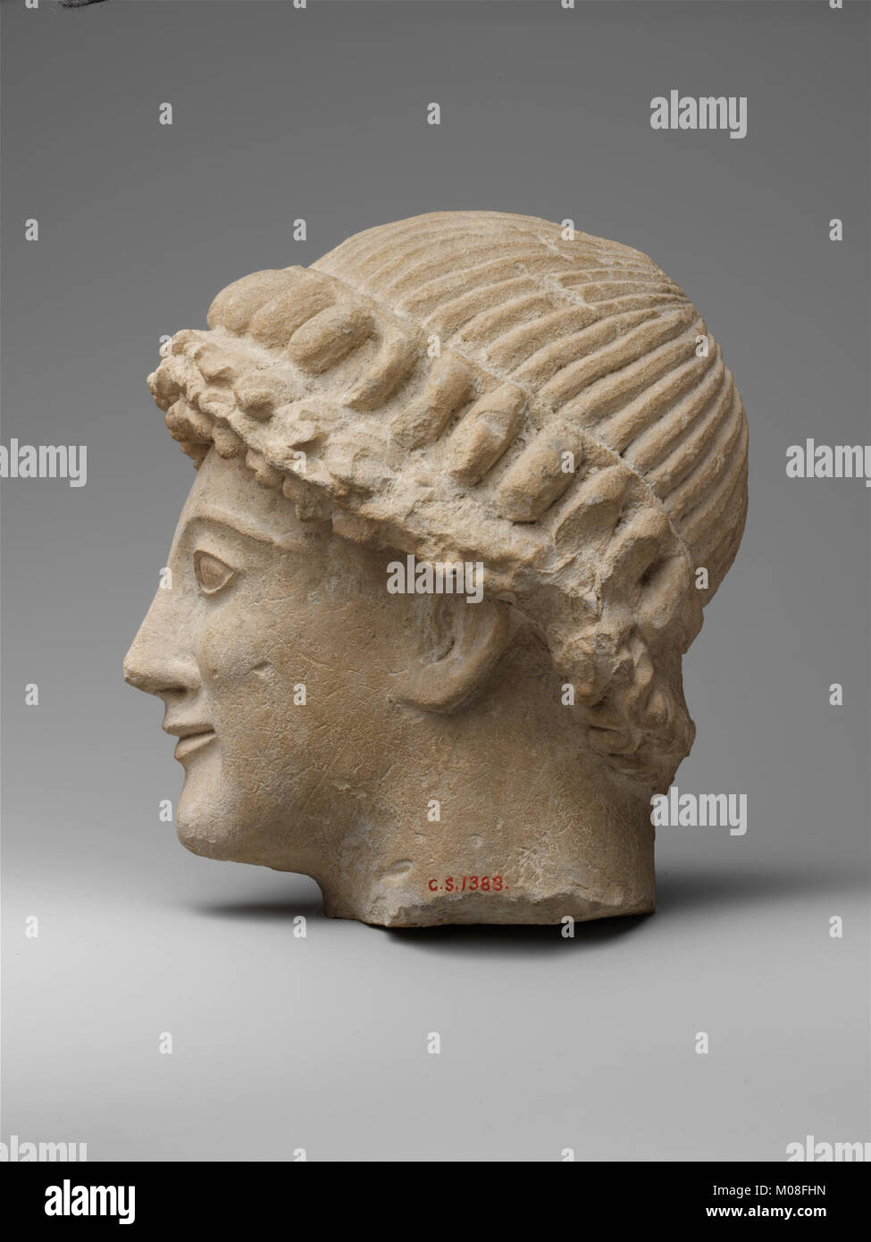 A limestone head of a youthful figure, depicting realistic facial ...