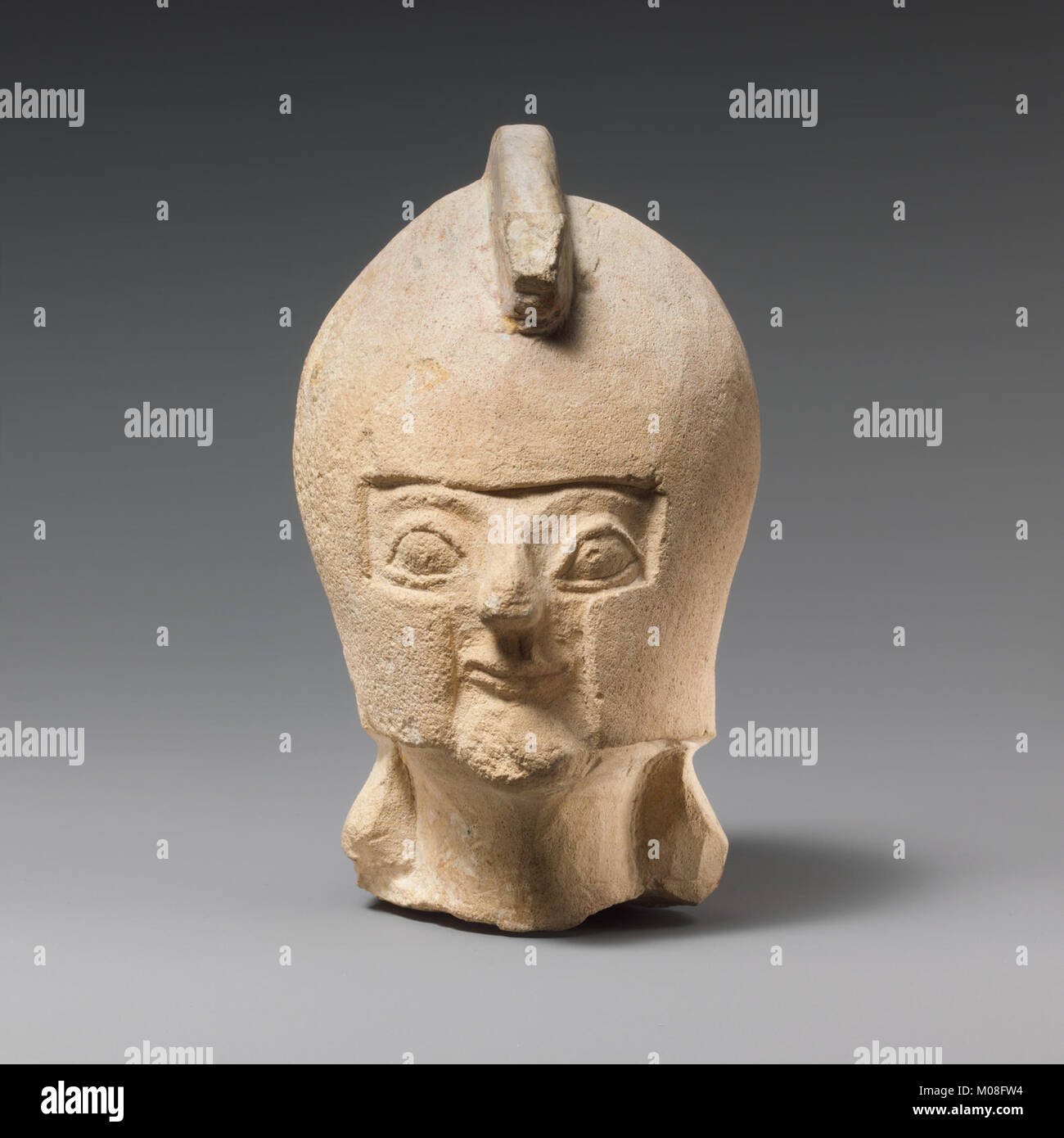 This limestone head, depicting a warrior wearing a crested helmet, is ...