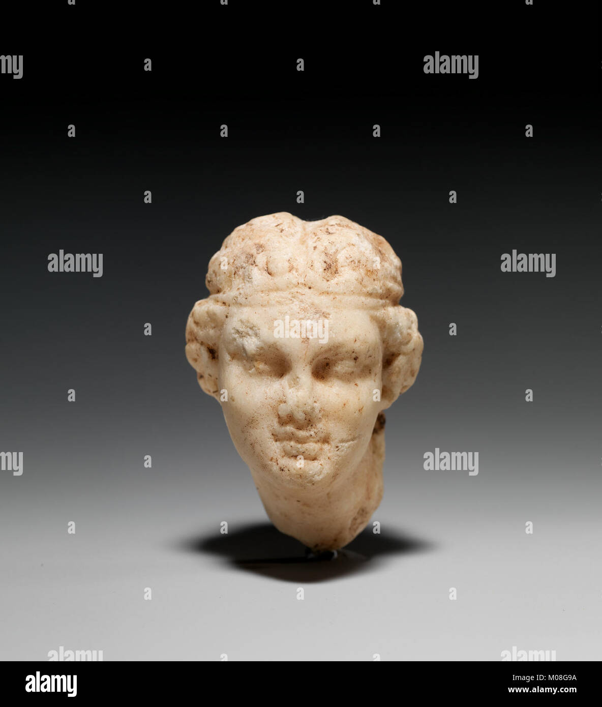 This marble sculpture features the head of a female satyr, a figure ...