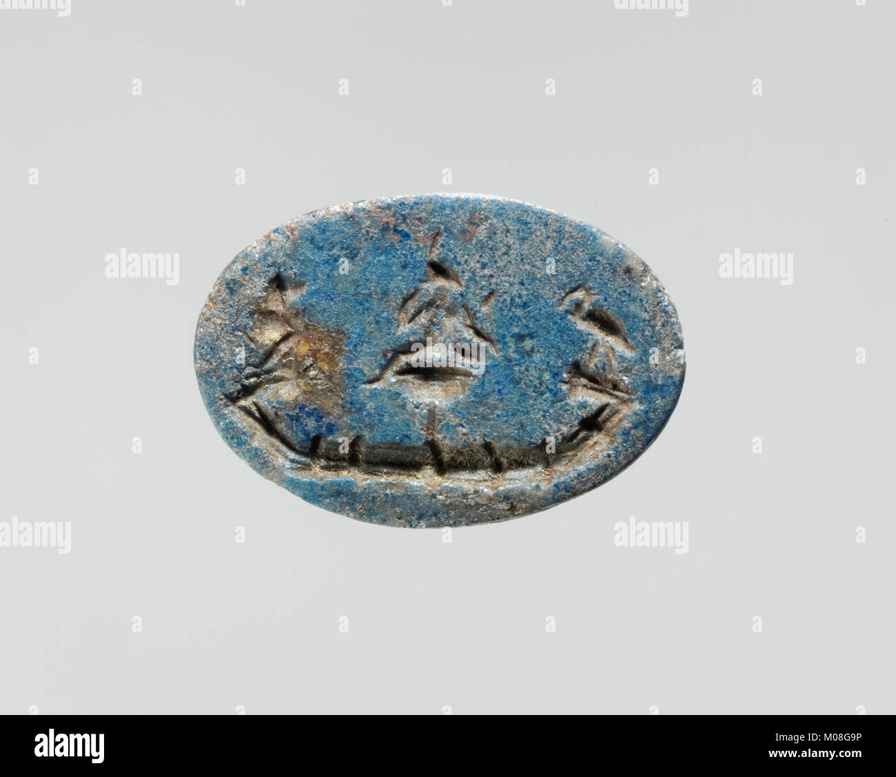 This lapis lazuli intaglio depicts Harpocrates in a papyrus boat ...