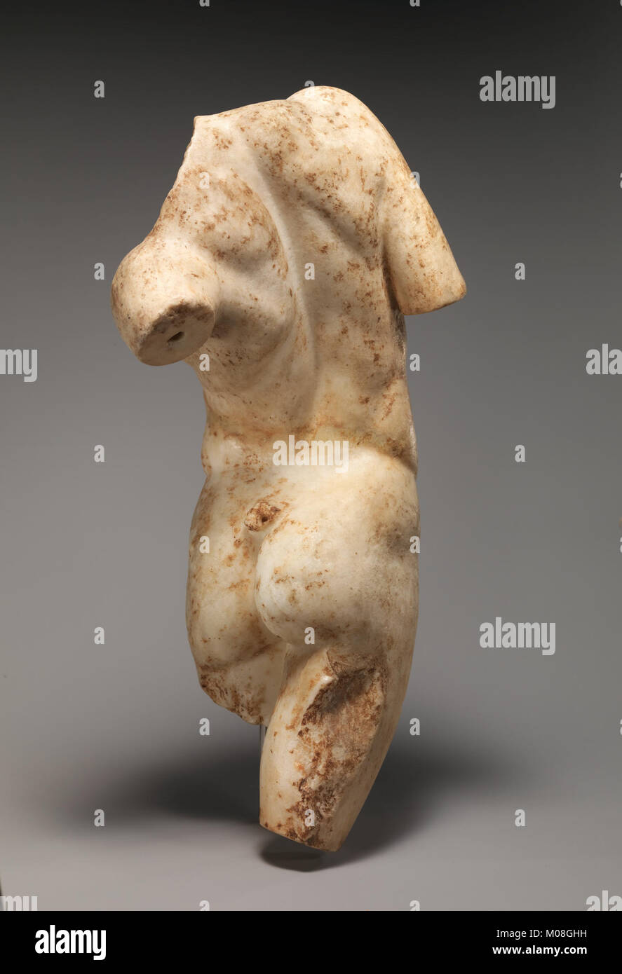 This marble statue depicts a young satyr, a mythological creature, in a ...
