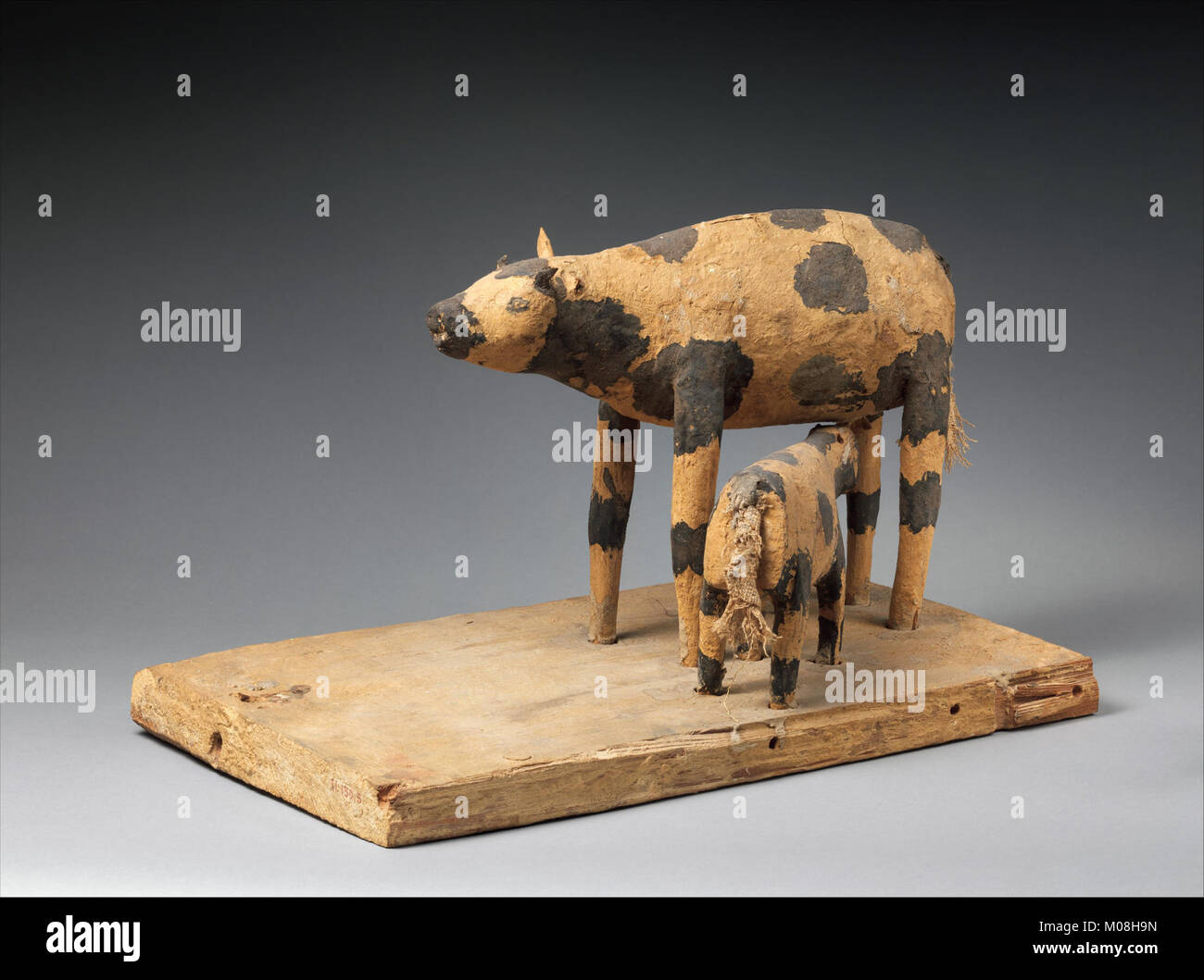 This model depicts a cow and her calf, demonstrating ancient ...
