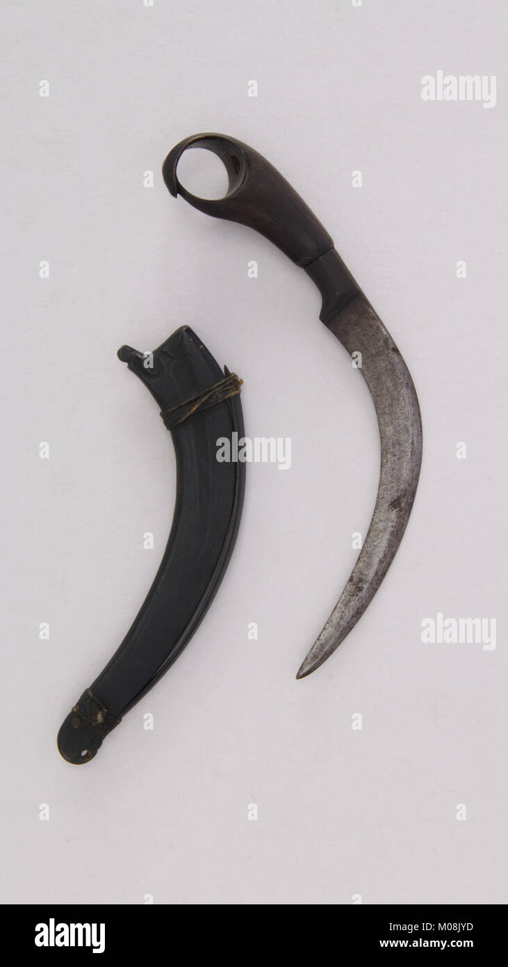 This Korambi knife with steel blade and decorated sheath serves as a ...