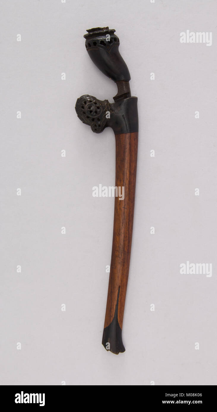 This knife, known as Bade-bade, comes with a sheath and is an example ...