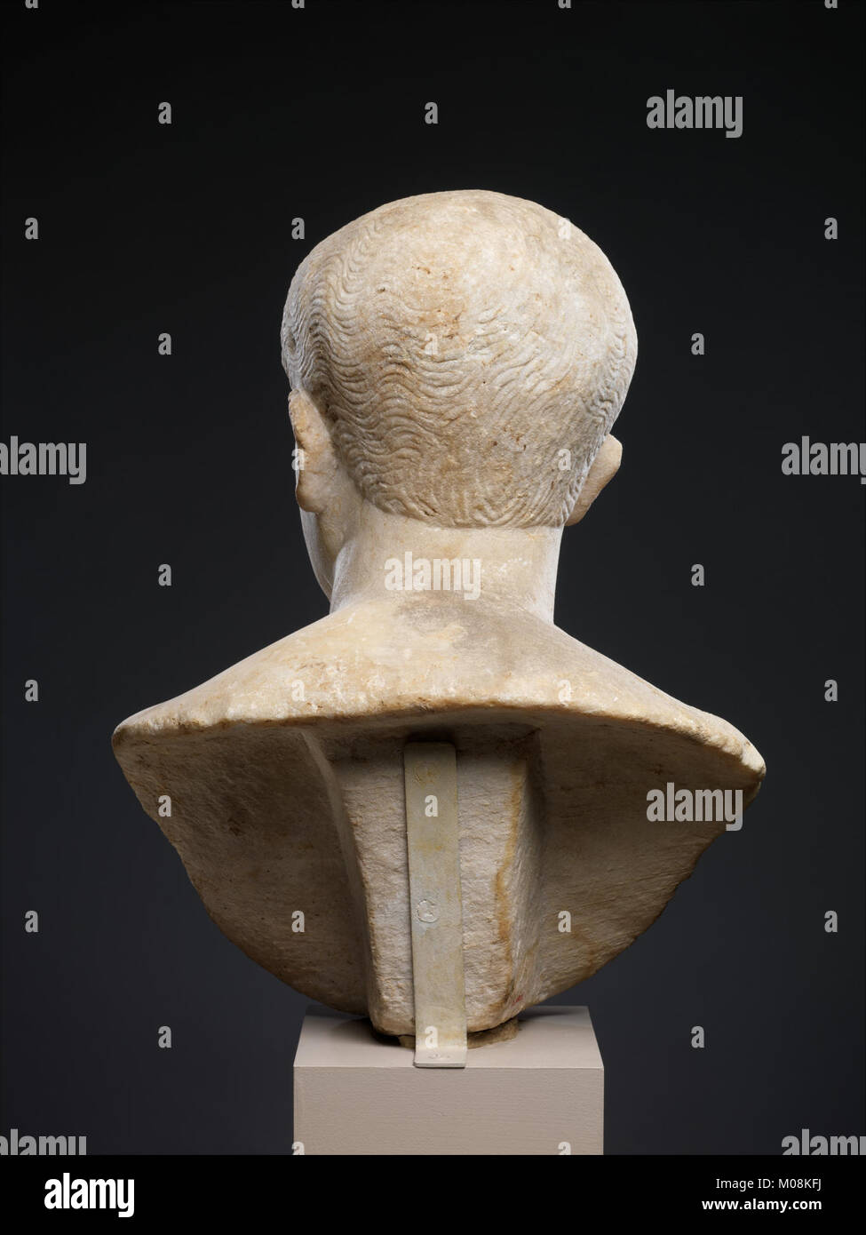 This marble portrait bust depicts a male figure, highlighting classical ...