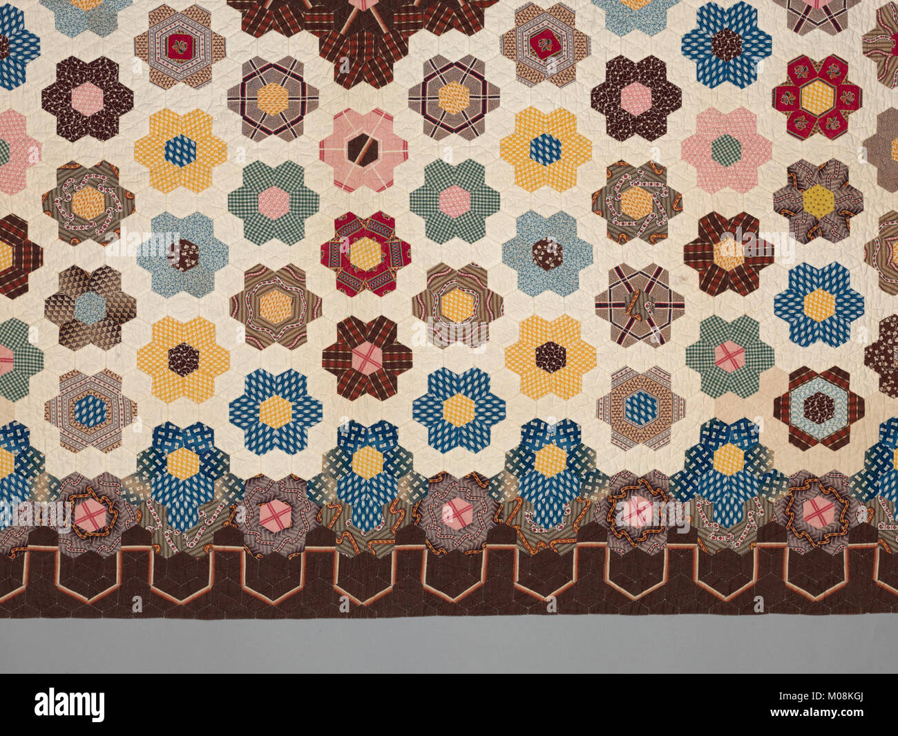 This honeycomb quilt, part of the MET collection, showcases a ...