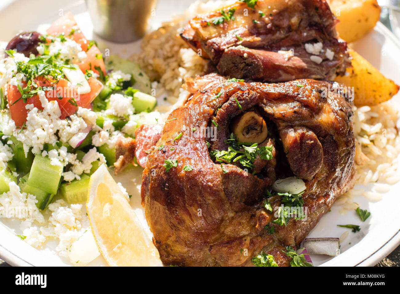 Hot and juicy roasted lamb with greek salad. Authentic Greek food Stock ...
