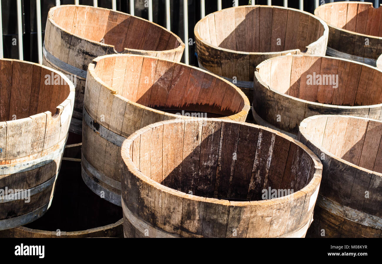Old wooden half barrels. Ex wine casks having a second life to be used ...