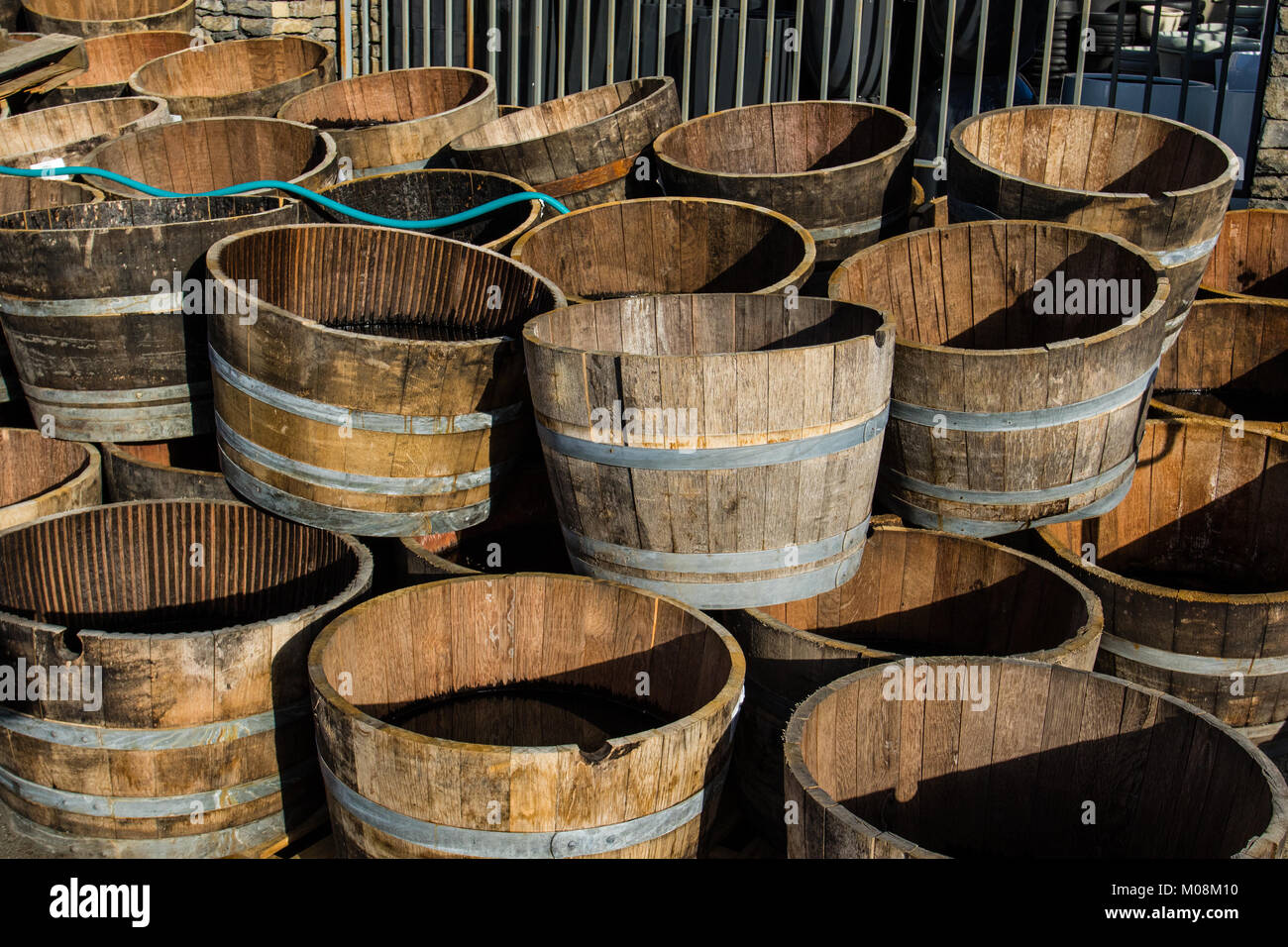 Stacked old wooden half barrels at gerden store is about to have second ...