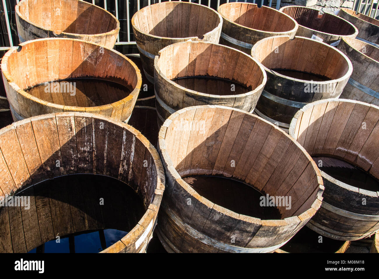 Stacked old wooden half barrels at gerden store is about to have second ...