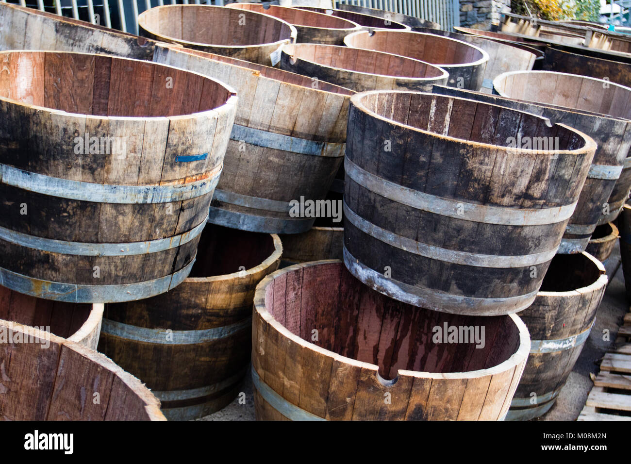 Old wine barrels cut in half to be used as decoration Stock Photo - Alamy
