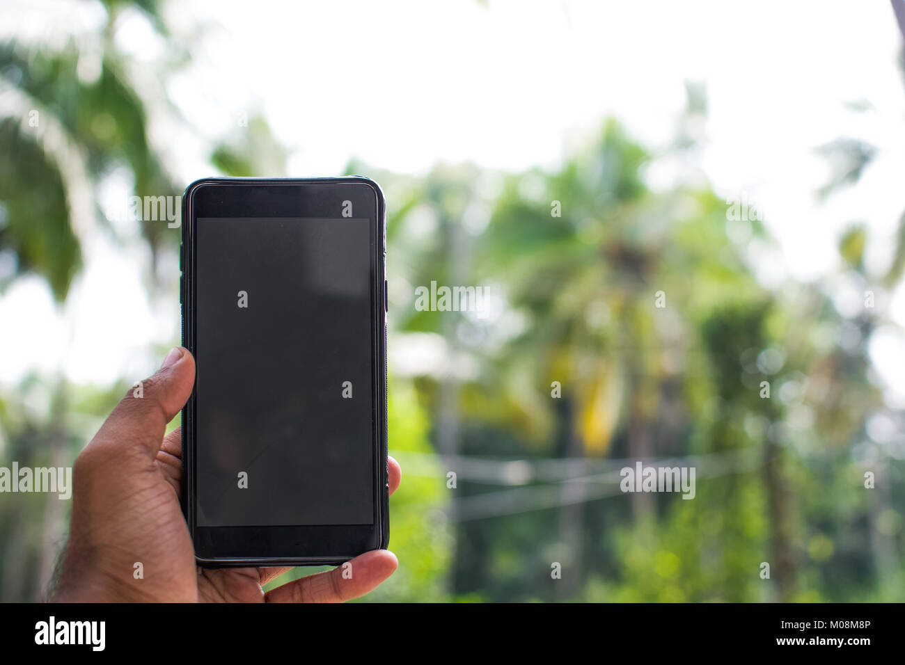 Man holding mobile in hand Stock Photo - Alamy