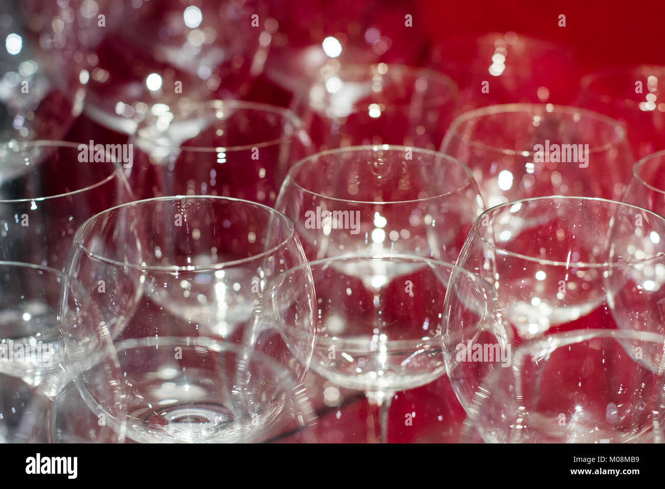 Elegant luxury shiny wine glasses lined up in rows on bar table ...