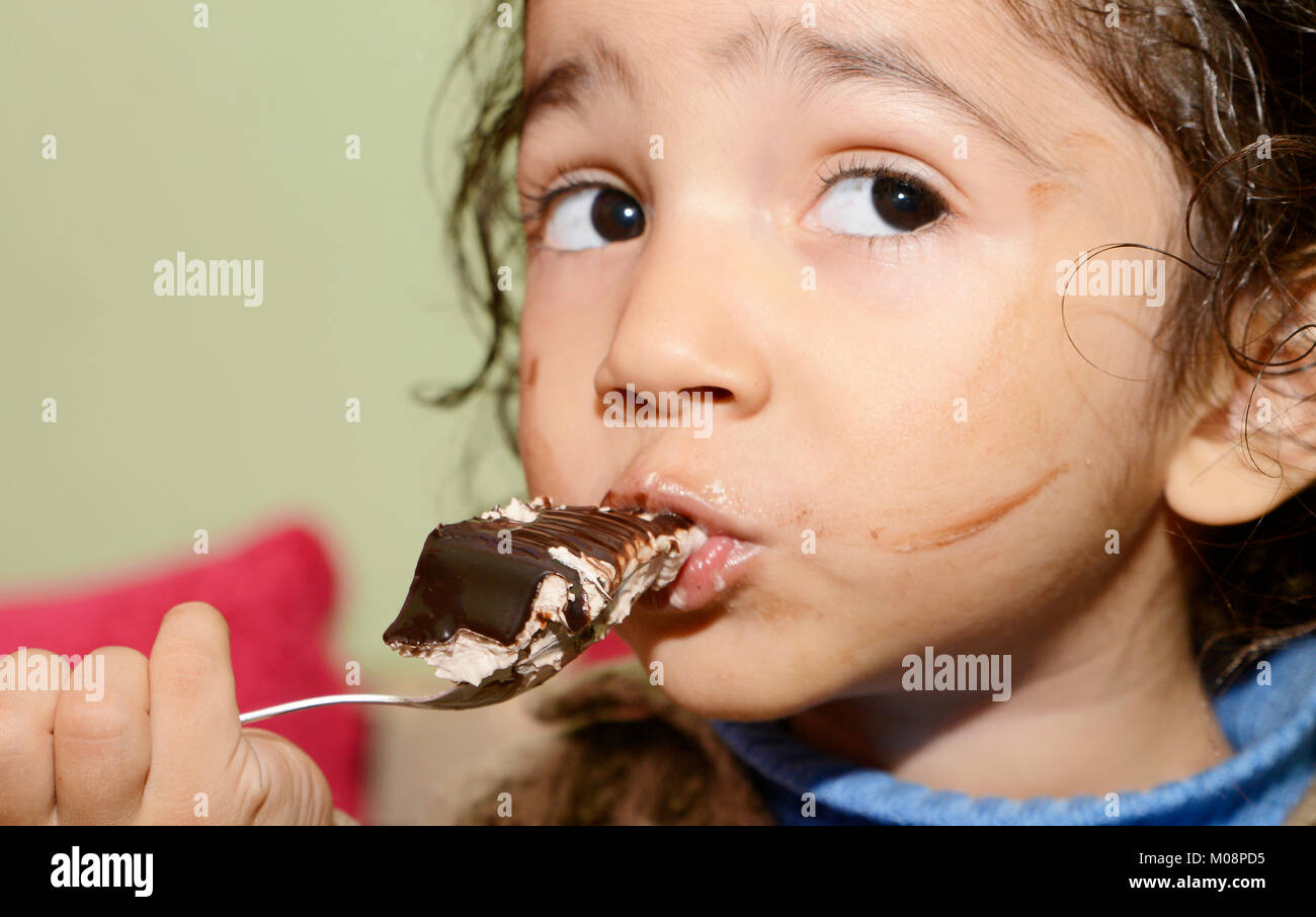 Little boy eating cake Stock Photo - Alamy