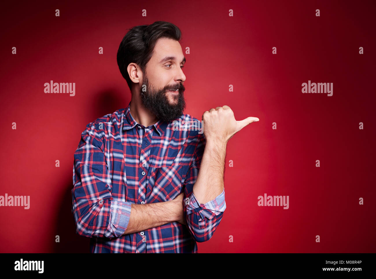 Handsome man pointing at copy space Stock Photo - Alamy