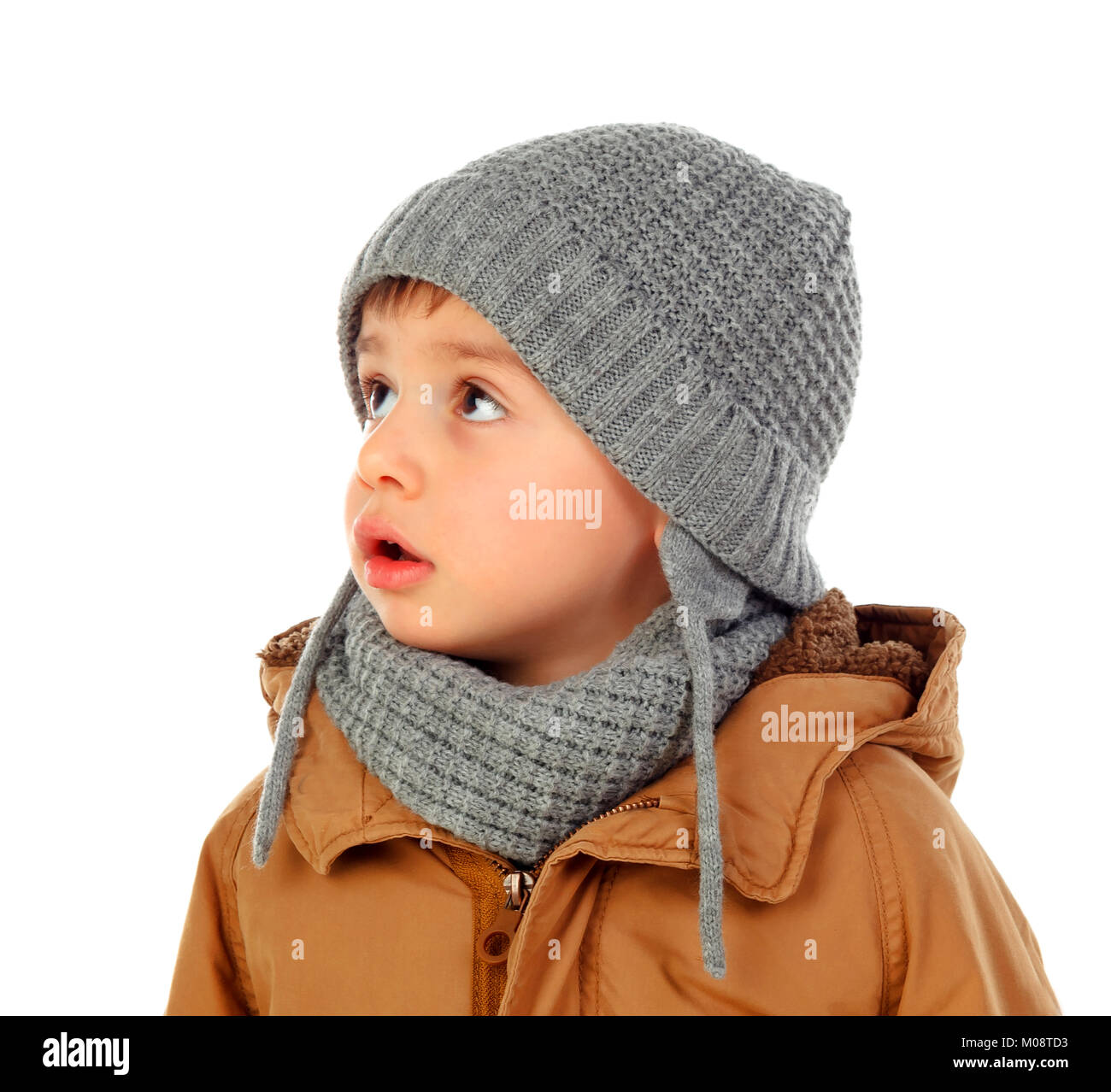 Beautiful child with wool scarf and coat isolated on a white background ...
