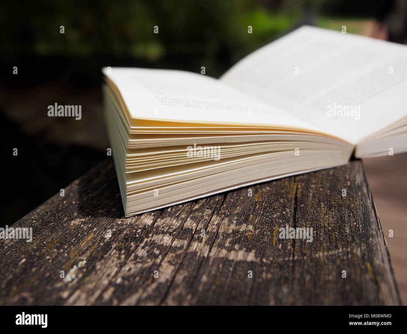 Open book on the wooden fence Stock Photo - Alamy