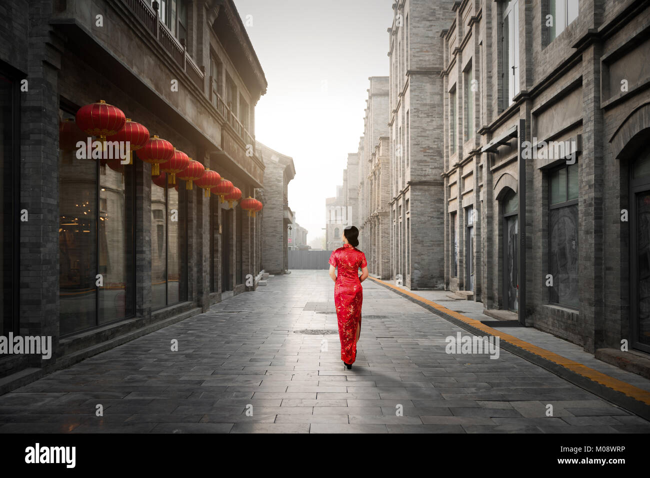 Asian young woman in old traditional Chinese dresses in Hutong village ...