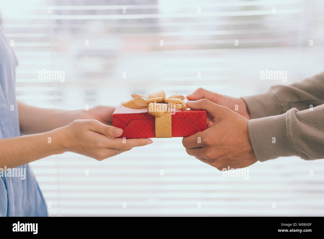 Couple in love. Romantic man giving gift to his girlfriend Stock Photo ...
