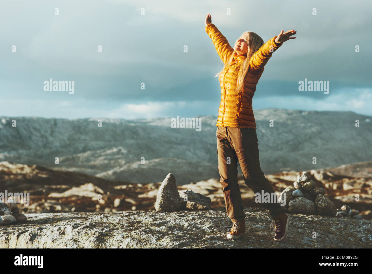Happy Woman raised hands enjoying landscape in mountains outdoor ...