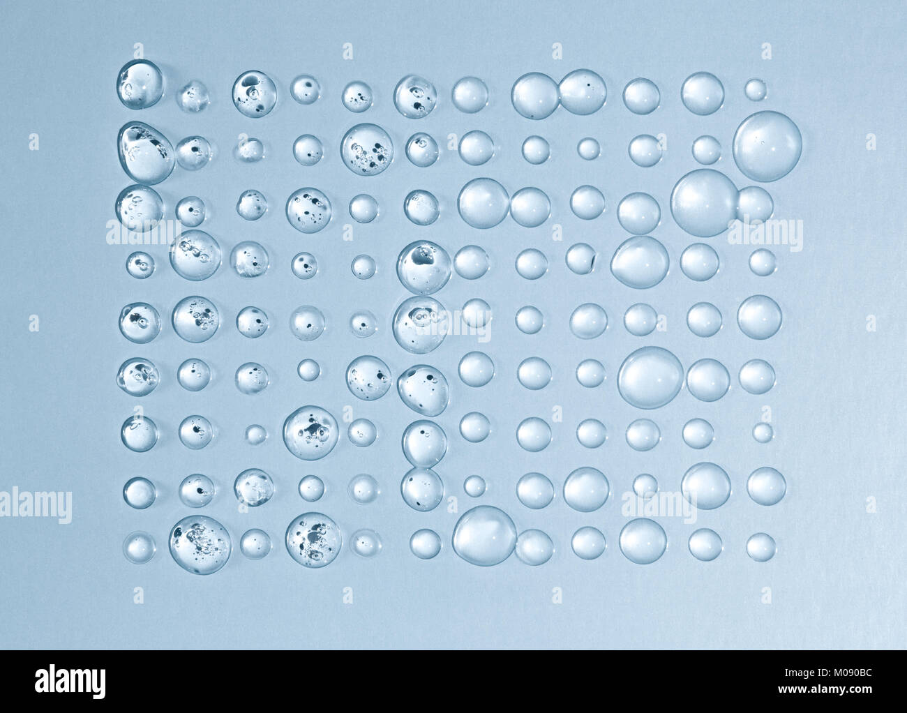 Straight rows of a drop of water on a blue background in the form of a ...