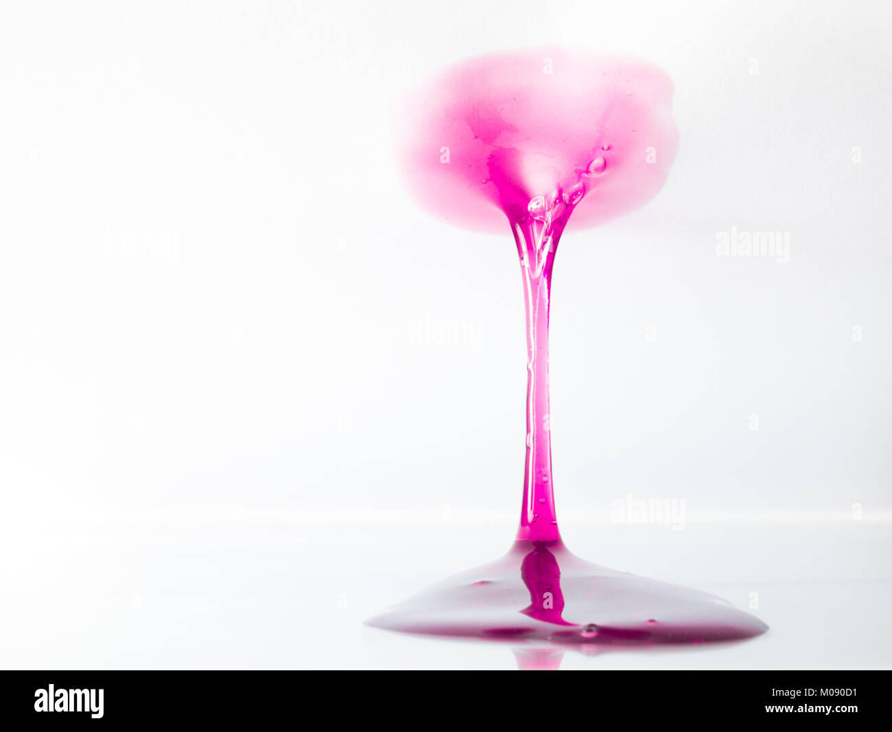 The viscous substance in the form of a colored gel is stretched between ...