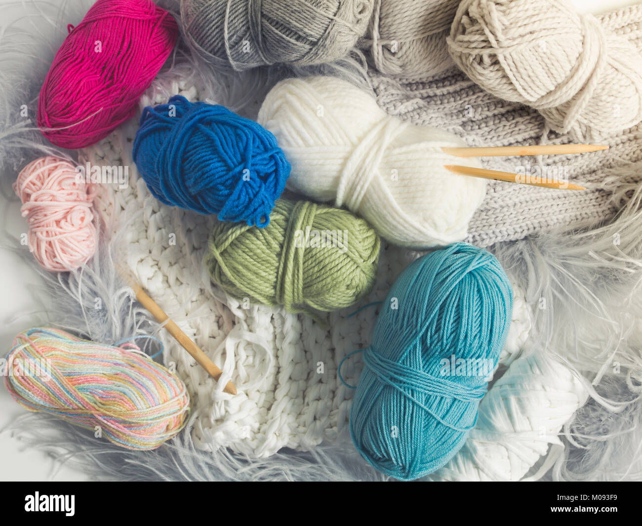 different kinds of colorful wool on white floor Stock Photo - Alamy
