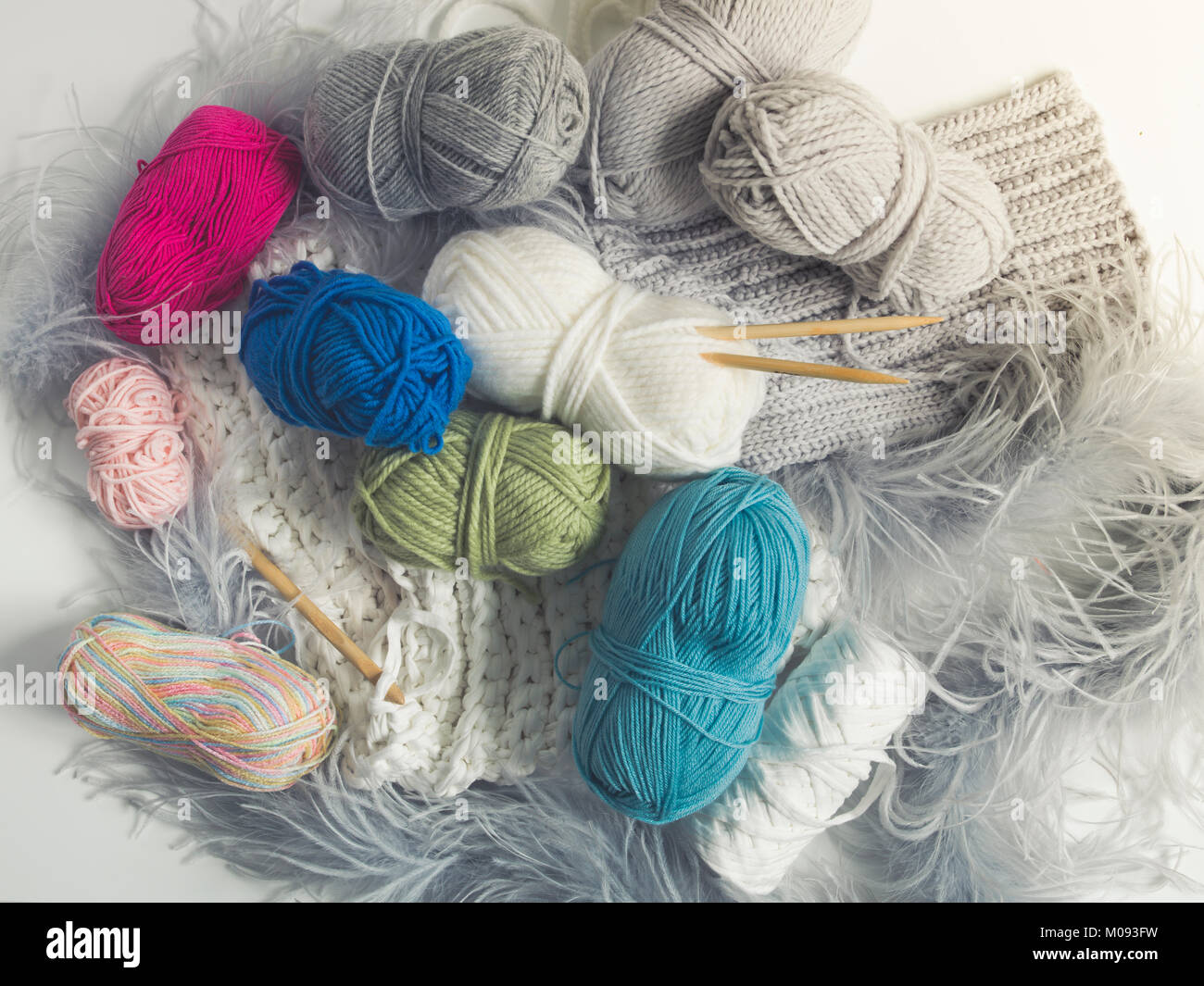 different kinds of colorful wool on white floor Stock Photo - Alamy