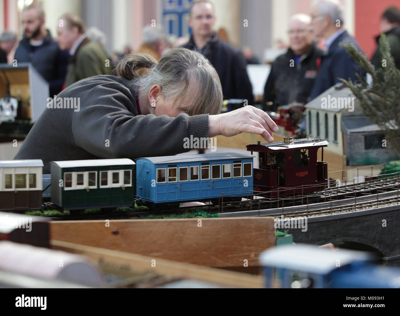 A woman checking a model of a steam train, during the London Model ...