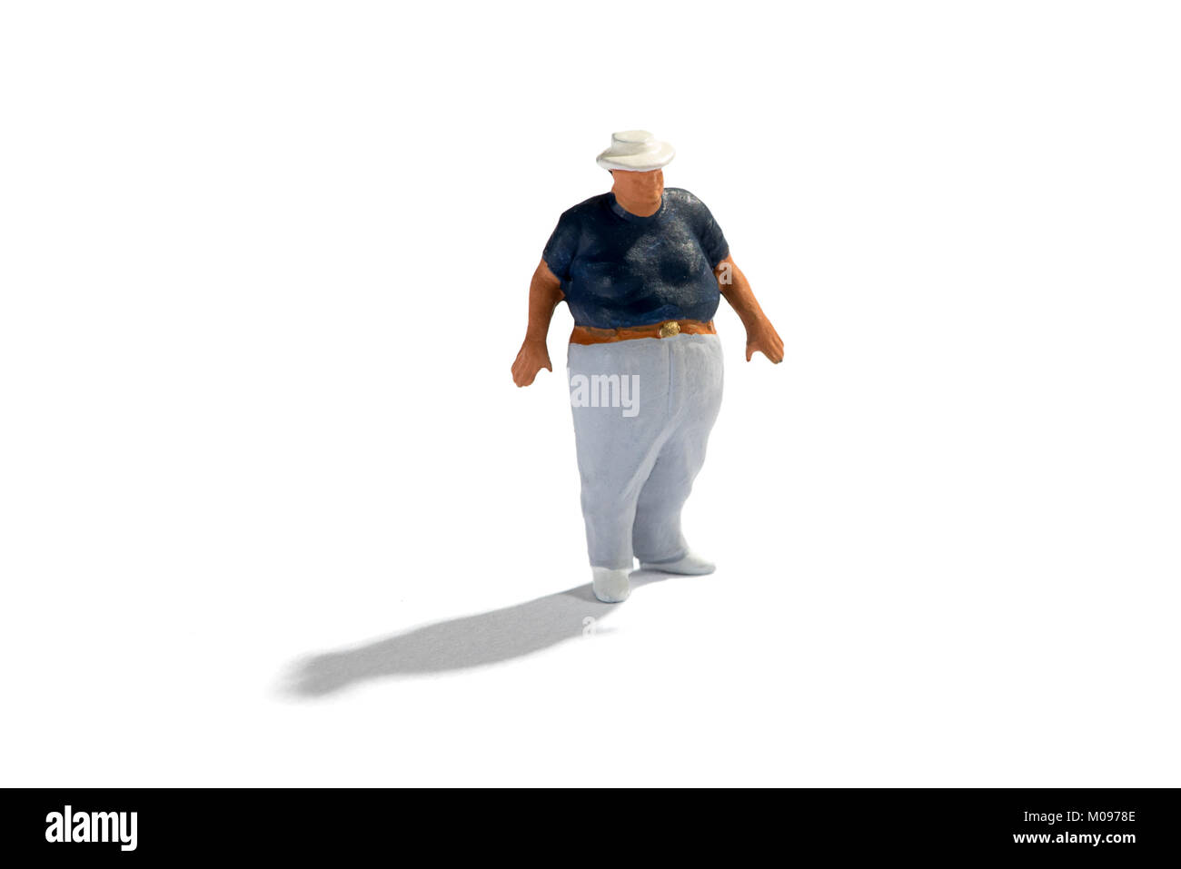Miniature Fat Boy figure with shadow on white in a concept of ...