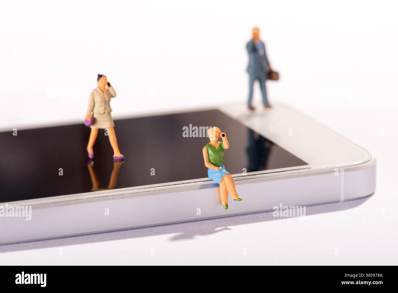 Miniature figures on a phone hi-res stock photography and images - Alamy