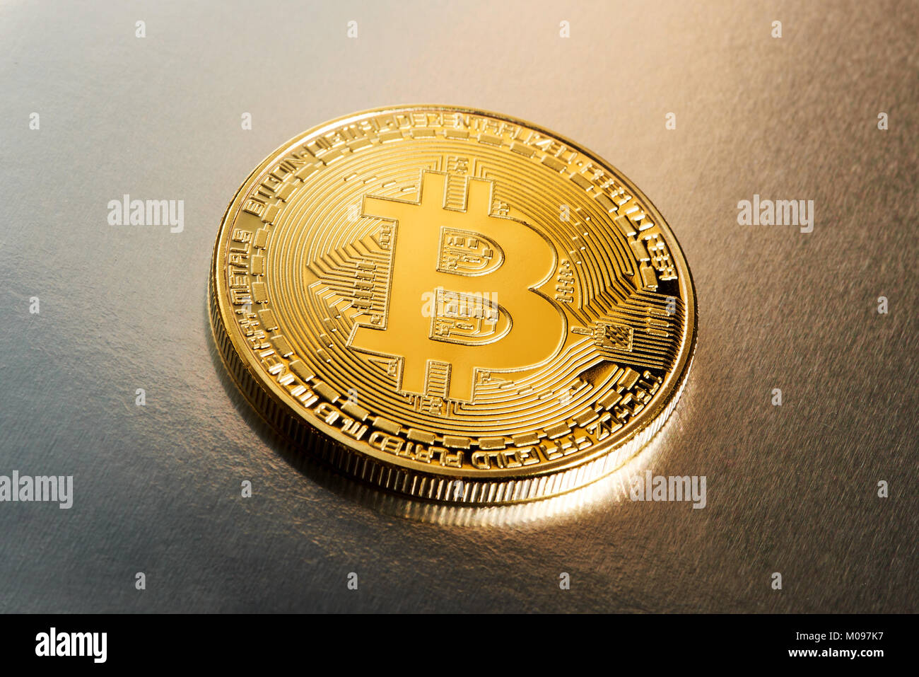 Single Bitcoin cryptocurrency on a silver through gold metallic ...