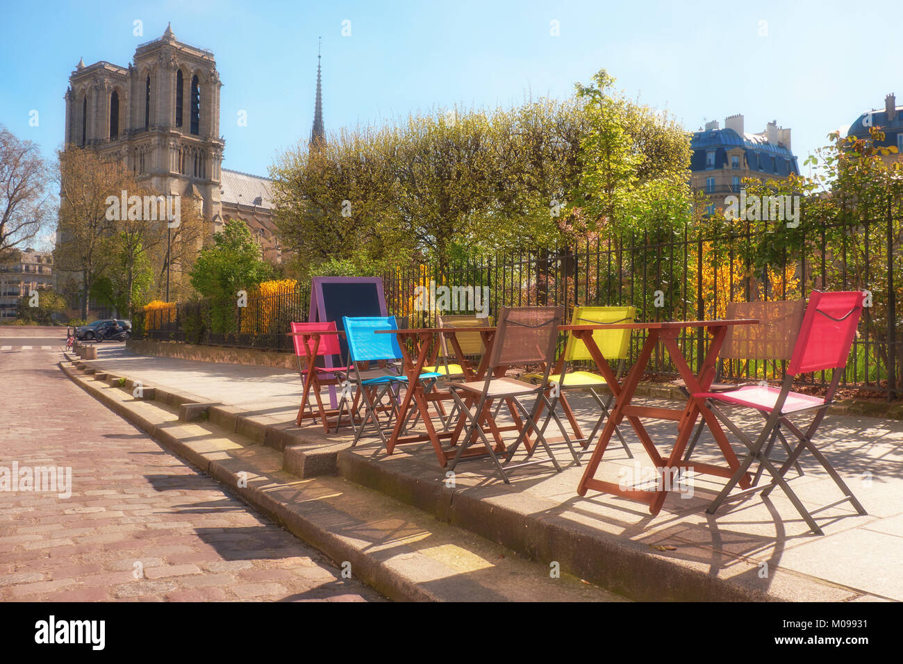 Tables and chairs of an outddoor cafe next to Notre Dame Cathedral in ...
