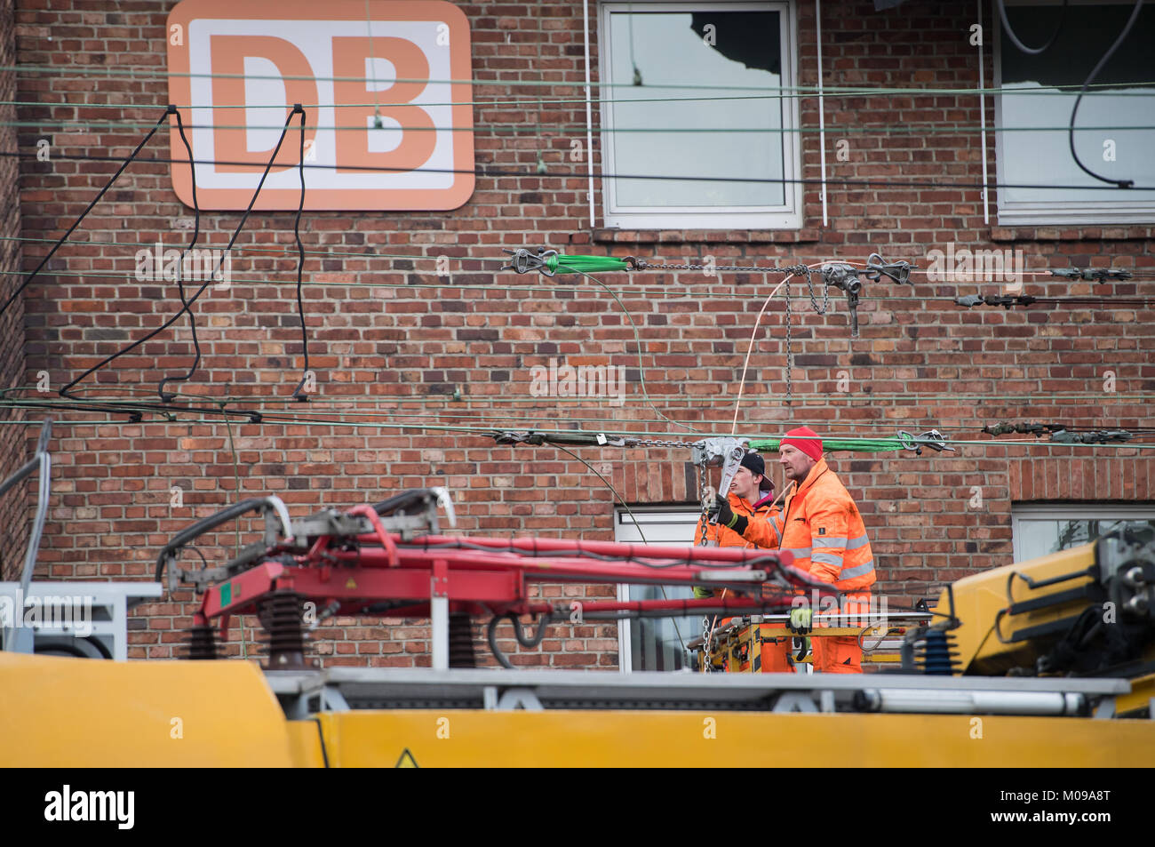 Employees of the German Railways (DB) repair a damaged train station ...