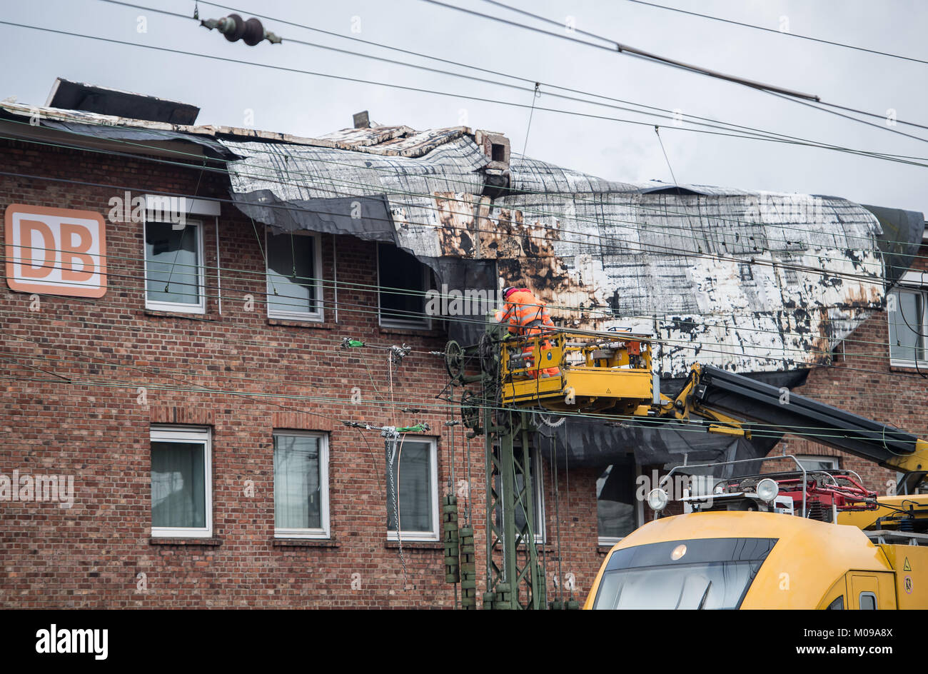 Employees of the German Railways (DB) repair a damaged train station ...