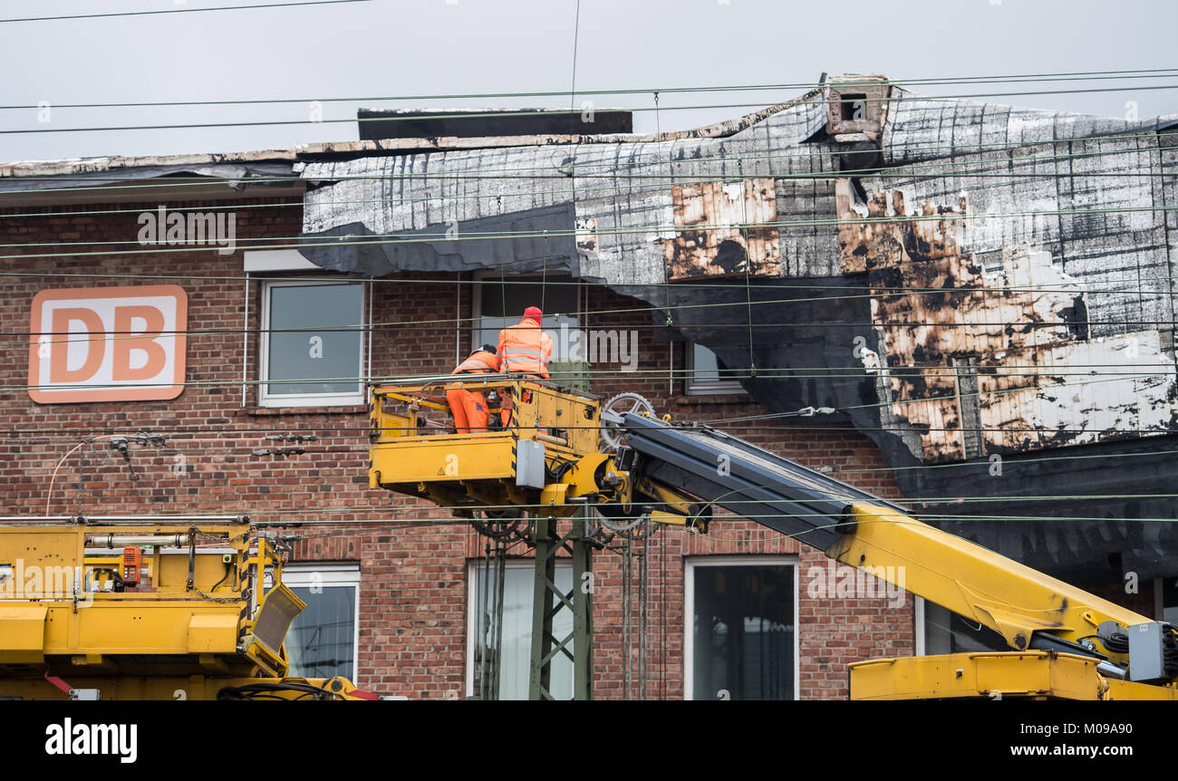 Employees of the German Railways (DB) repair a damaged train station ...