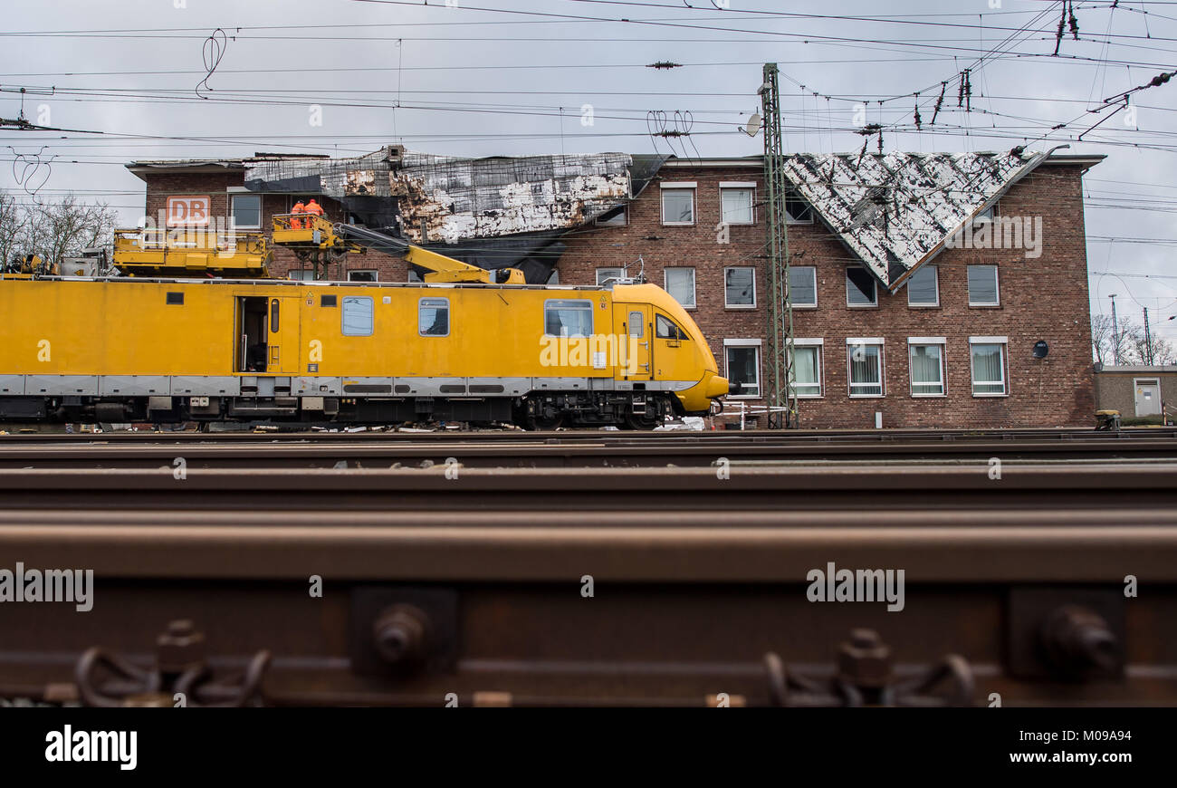 Employees of the German Railways (DB) repair a damaged train station ...