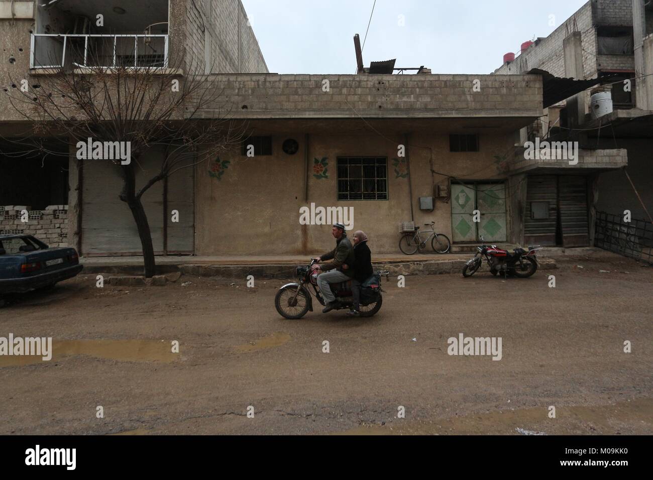 Mesraba, Syria. 18th Jan, 2018. A man seen riding with his daughter on ...
