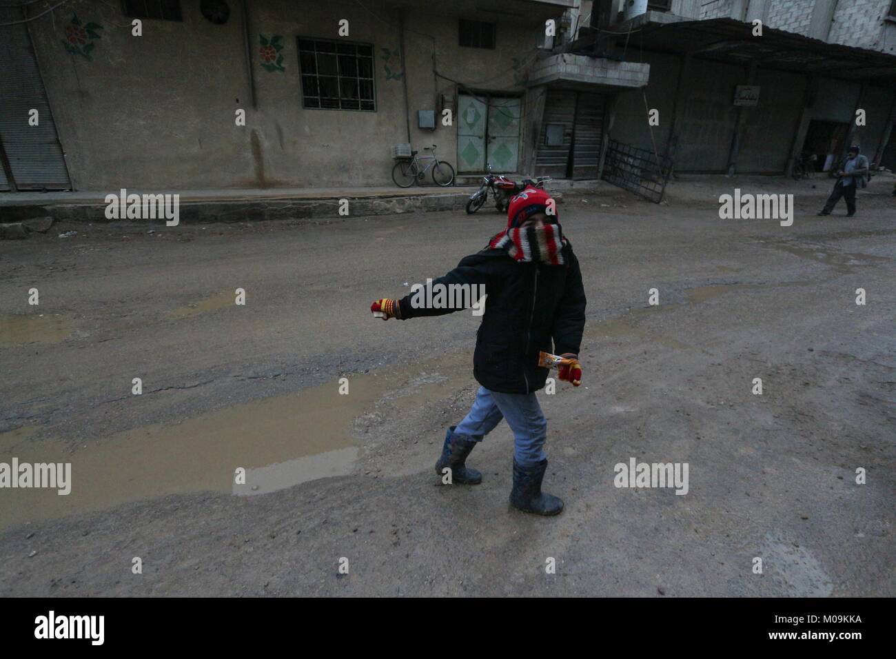 Mesraba, Syria. 18th Jan, 2018. A boy seen playing in the street during ...