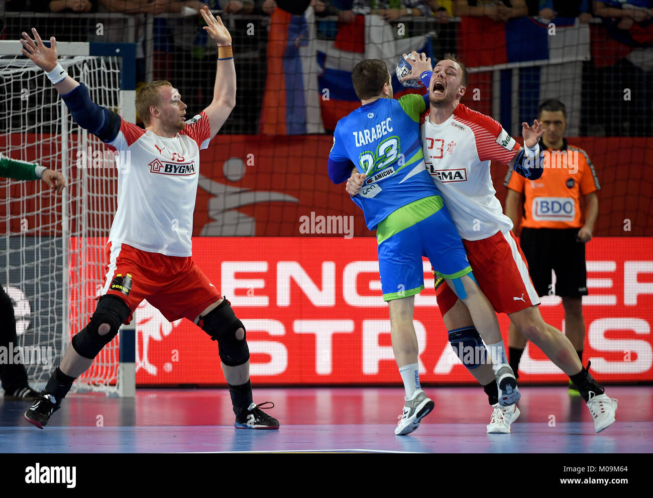 Slovenia's Miha Zarabec (C) and Denmark's Henrik Toft Hansen vie for ...