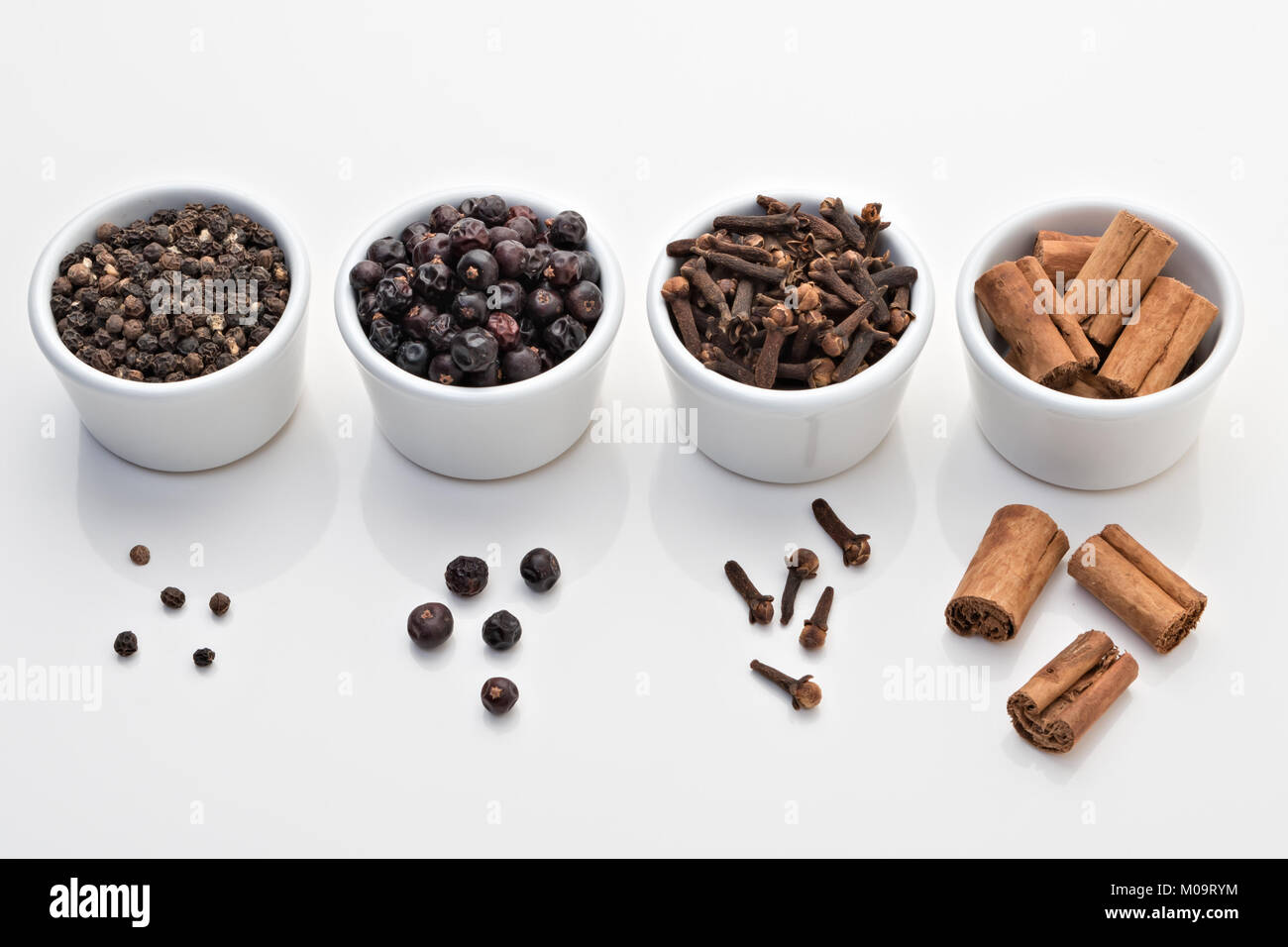 spices black pepper juniper cloves cinnamon in slats from above Stock ...