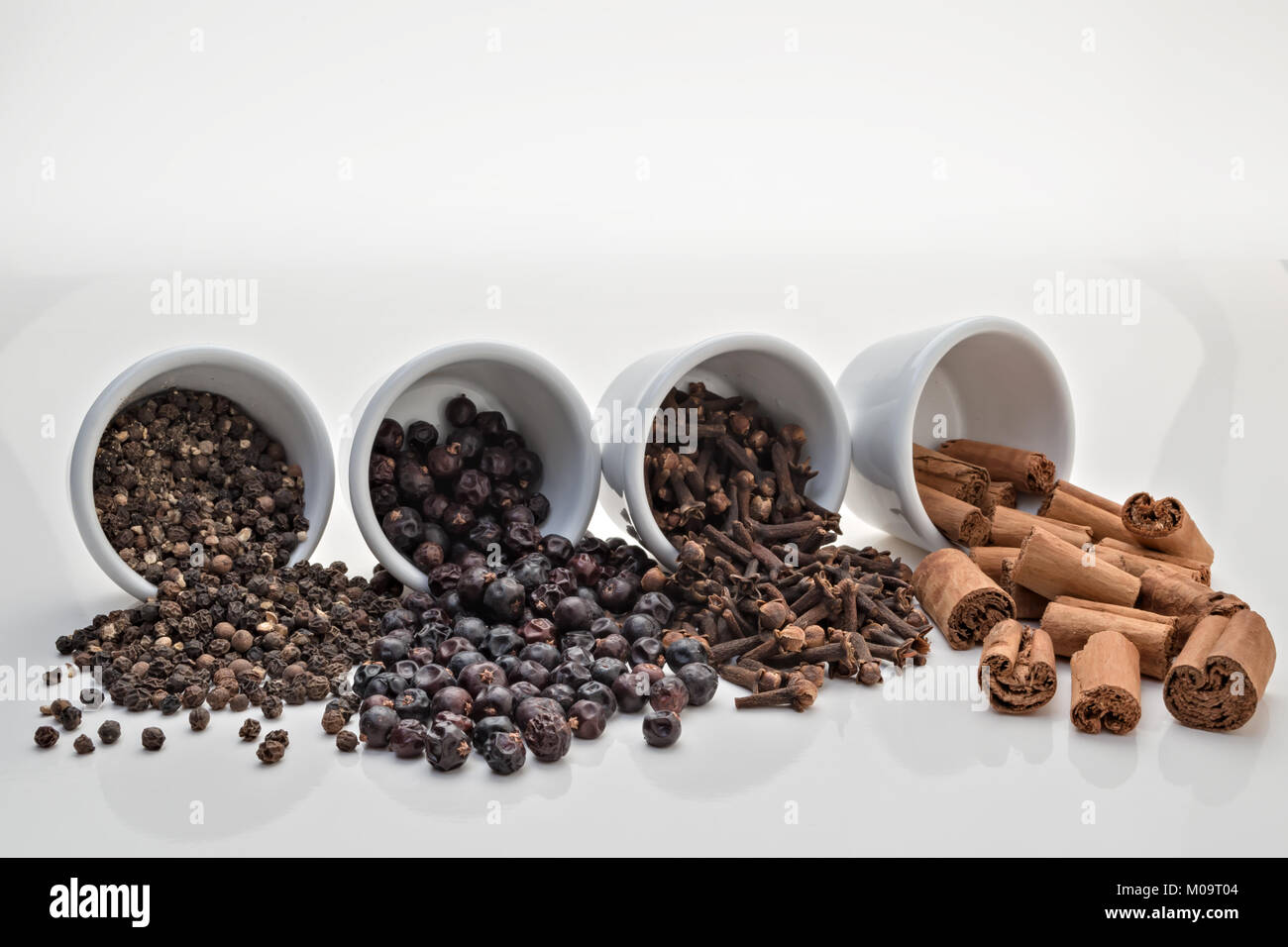 spices black pepper juniper cloves cinnamon in inverted slats Stock ...