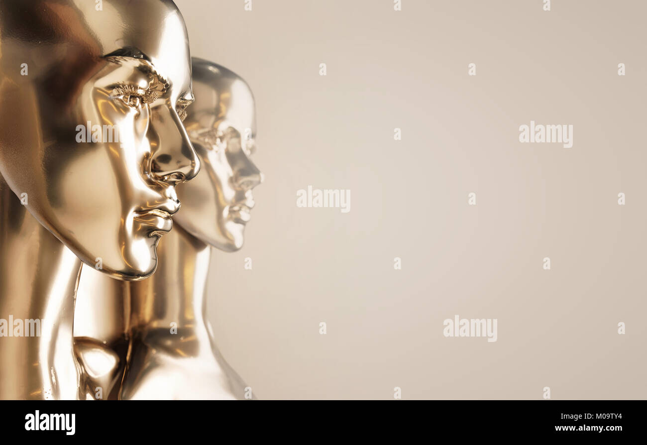 Two heads of human golden scupltures Stock Photo - Alamy