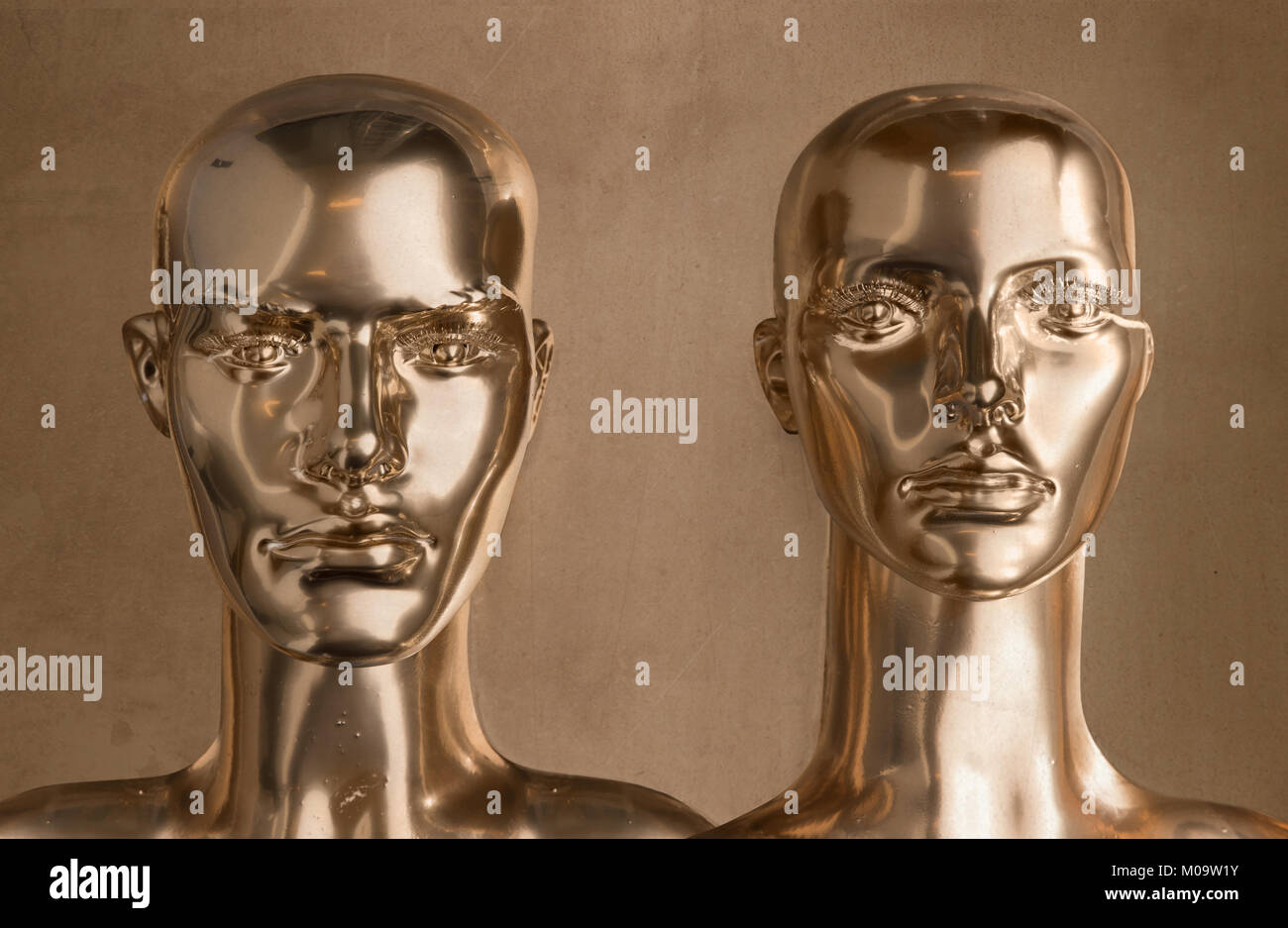 Two heads of human golden scupltures Stock Photo - Alamy