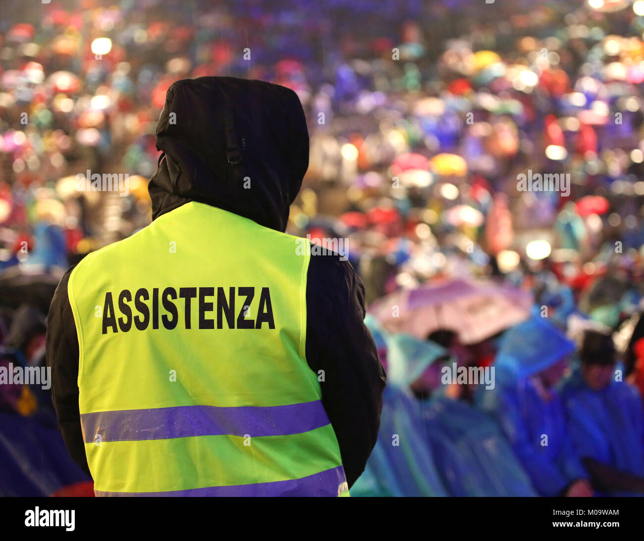 italian security guard during the event with text ASSISTENZA that means ...