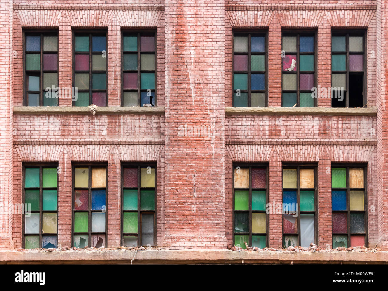 A brick wall with rectangular windows and multicolor frames Stock Photo ...