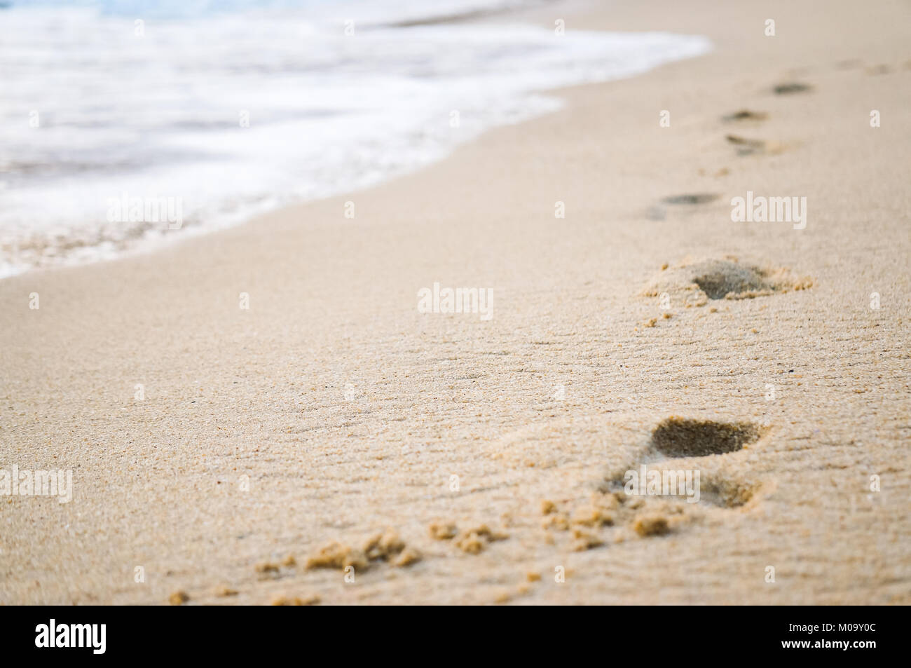 Footprints in the sand at sunset. Beautiful sandy tropical beach with ...