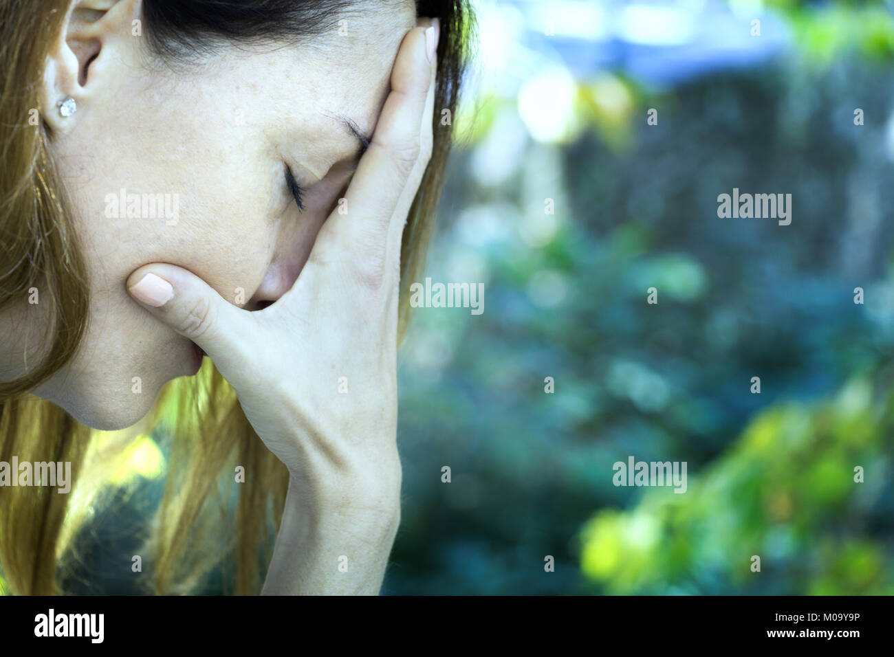 Portrait of a mature woman, 46 years, thinking, sad, looking down ...