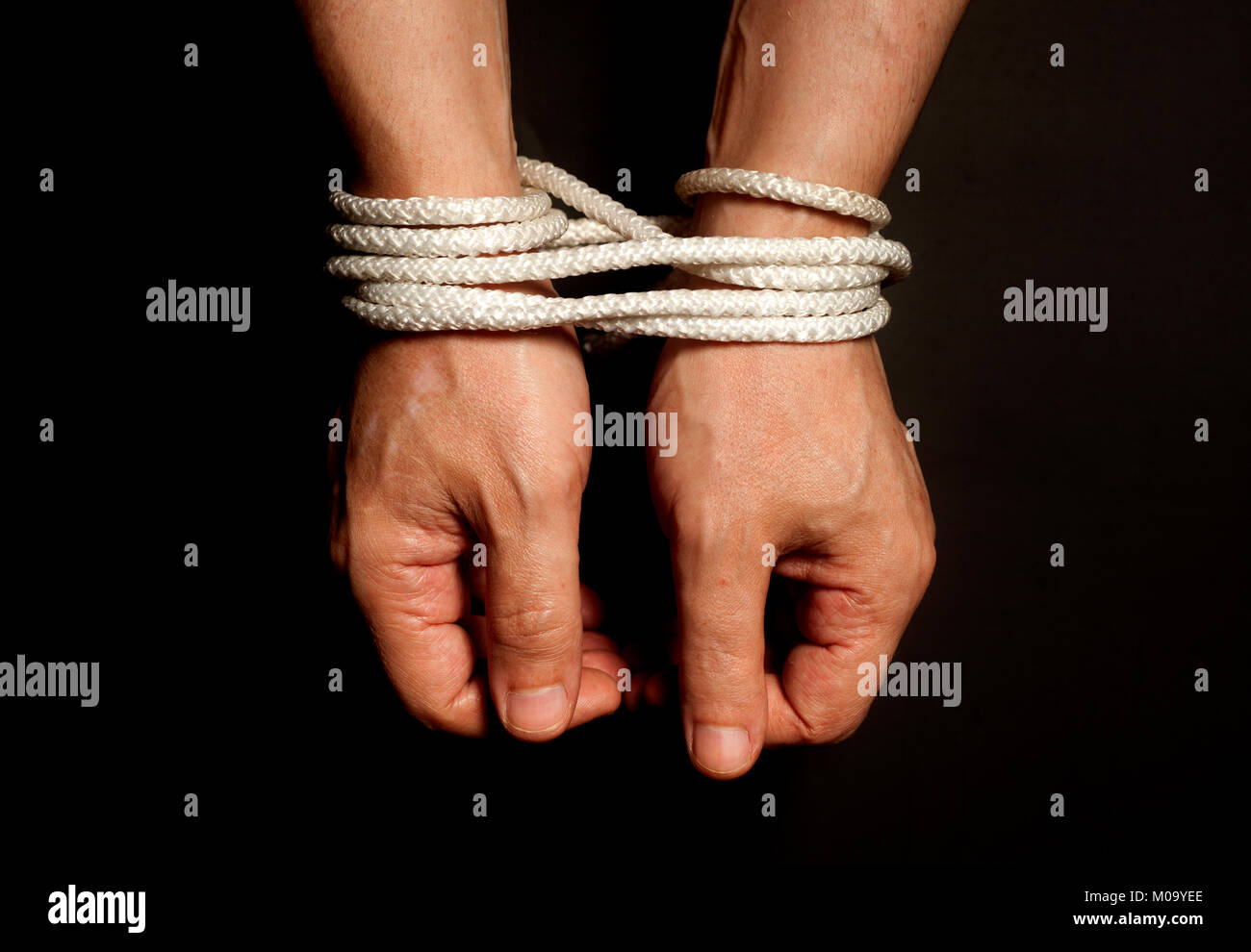 Male Hands Bound With Rope On Black Addiction Concept Stock Photo Alamy