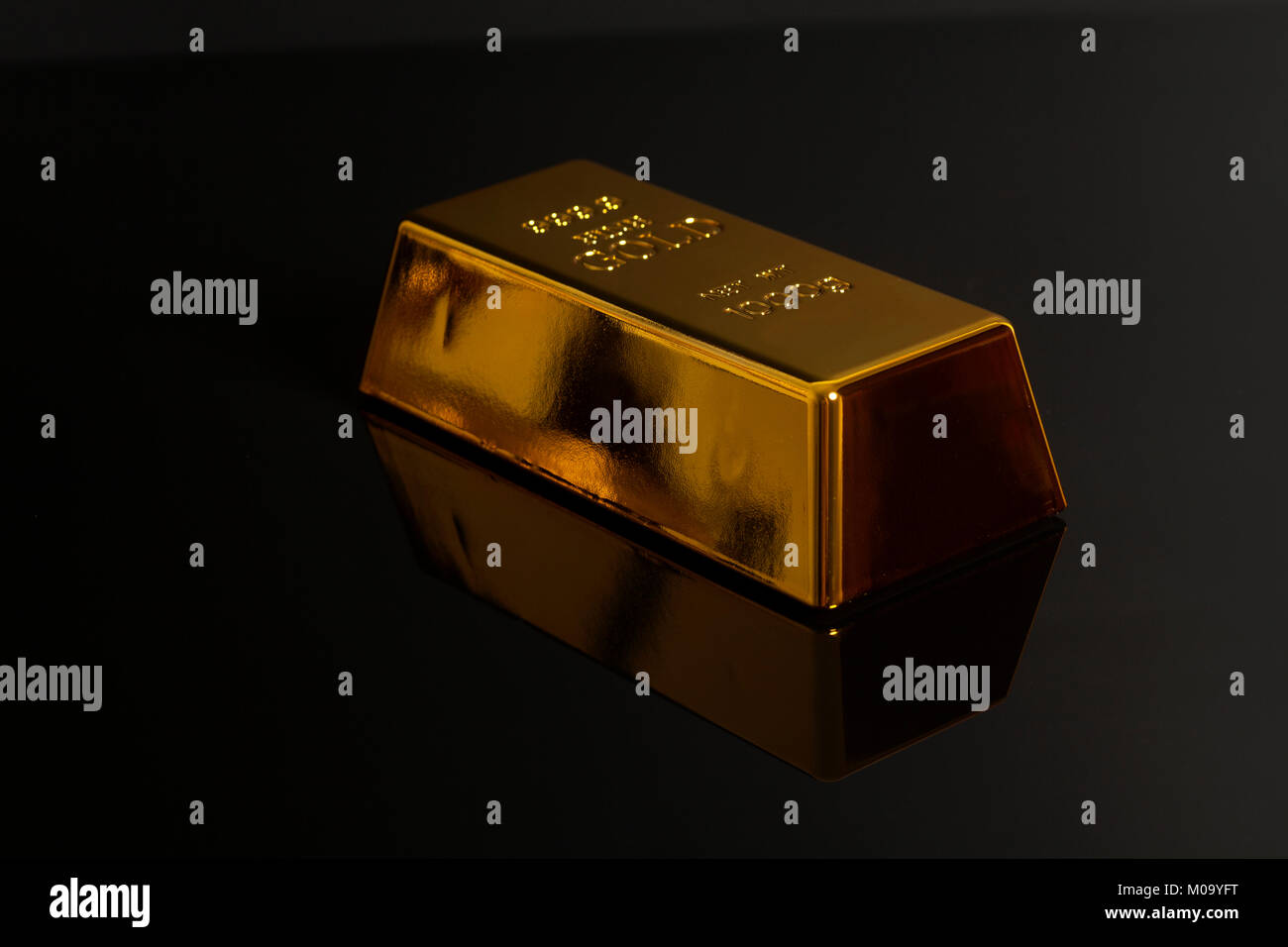 Gold bullion isolated on a black background Stock Photo - Alamy